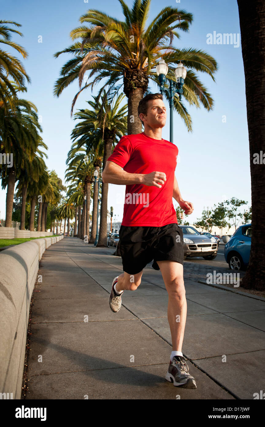 Man running on city street Stock Photo - Alamy