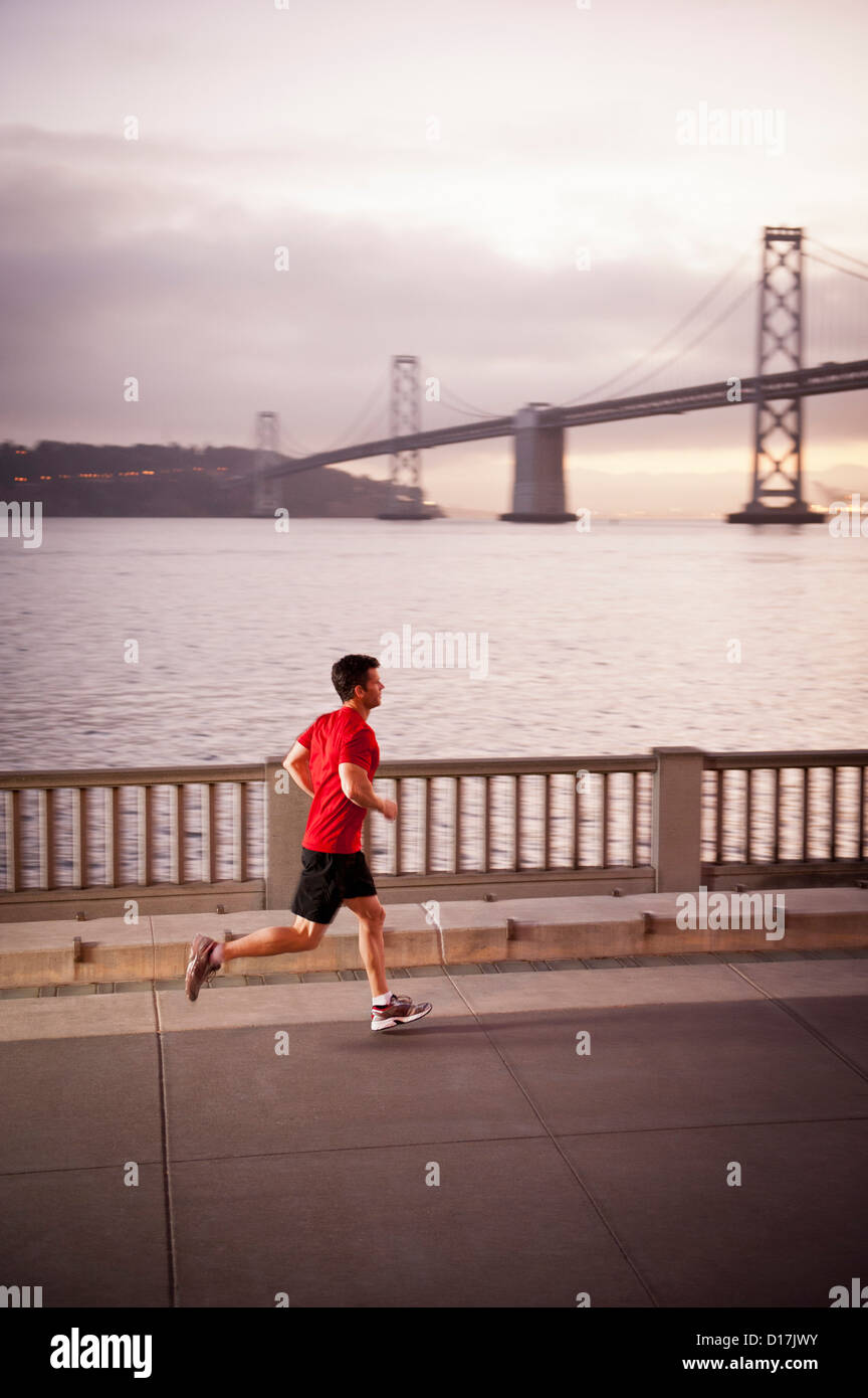 Man running on city street Stock Photo - Alamy