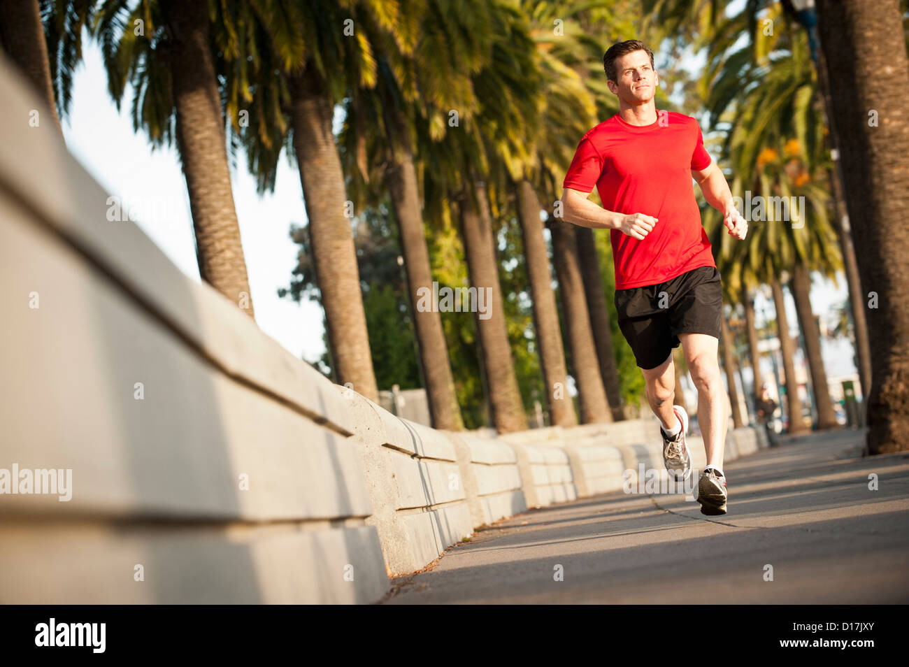 Man running on city street Stock Photo - Alamy
