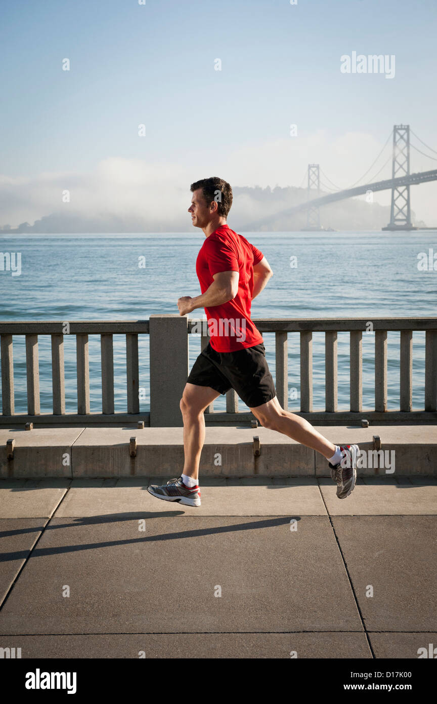 Man running on city street Stock Photo - Alamy