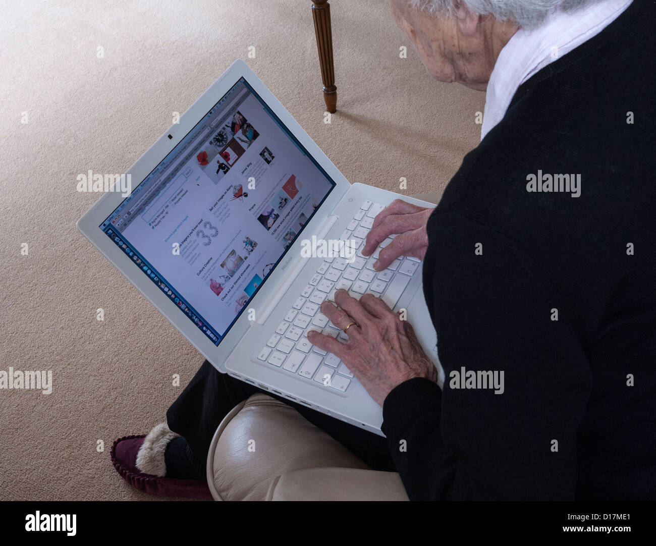 Elderly lady using a laptop computer hi-res stock photography and ...