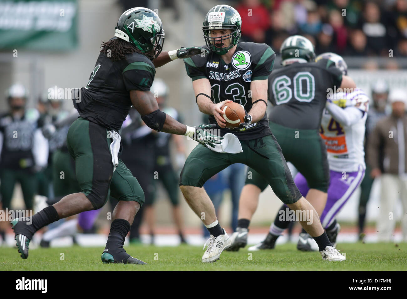 QB Thomas Haider (#13 Dragons) hands the ball to RB Tunde Ogun (#1 ...