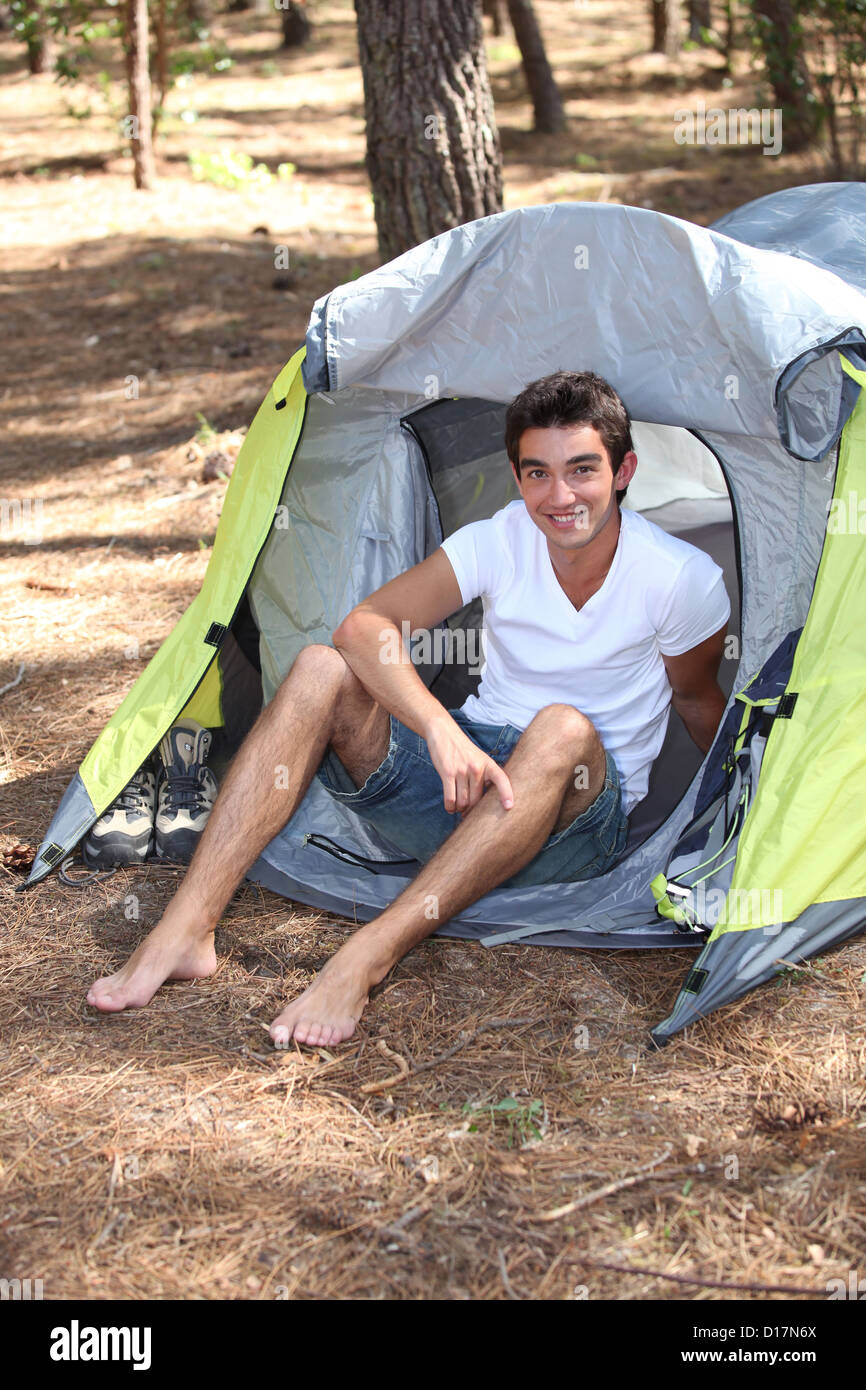 Young man camping Stock Photo - Alamy