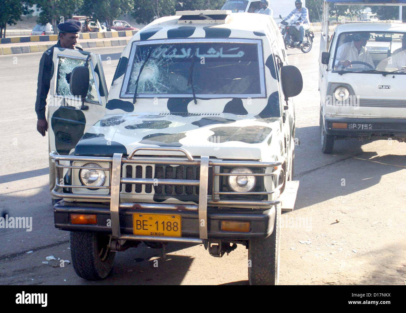 Police official inspects vehicle after firing incident on Money ...