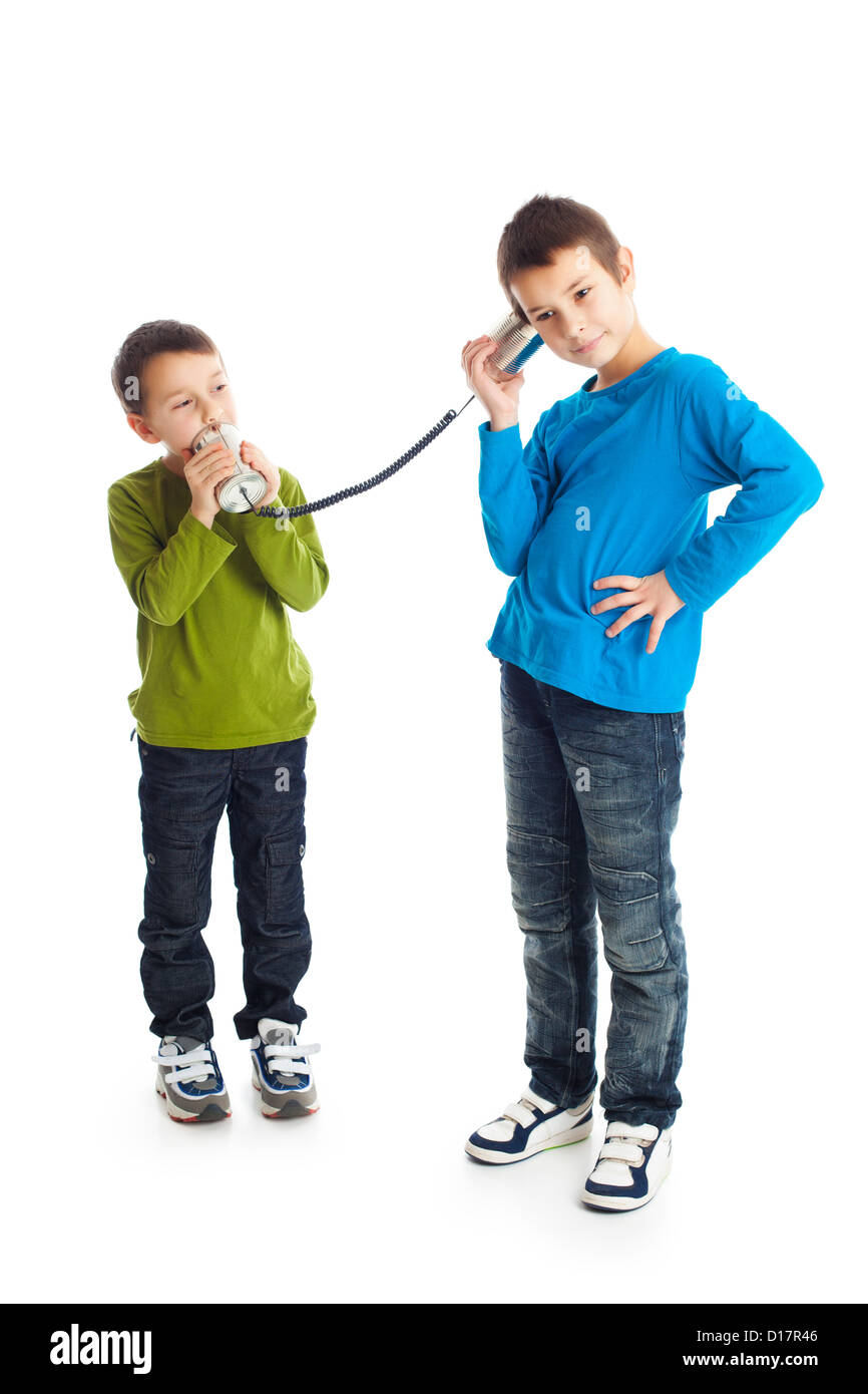 Two boys calling tin can phone. Studio shot Stock Photo - Alamy