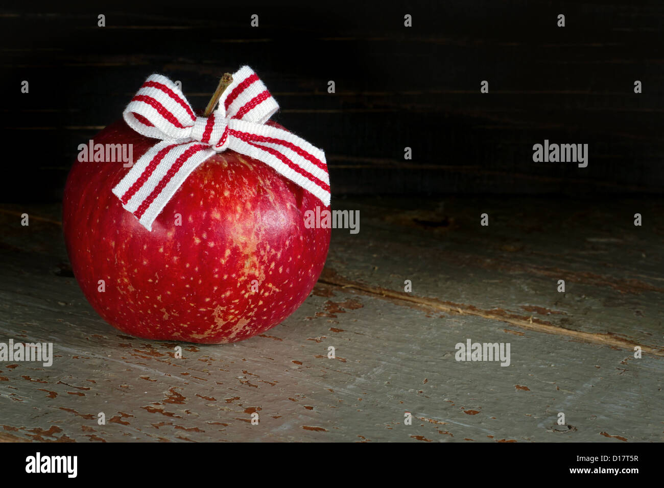 Red apple with Christmas bow on dark wooden rustic background Stock ...