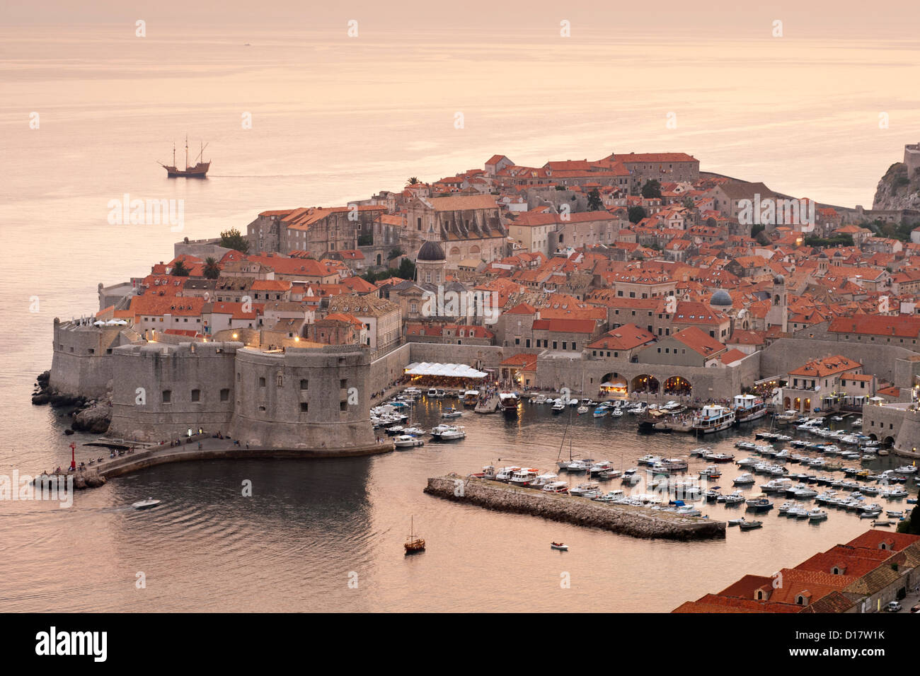 Dusk view of the old harbour port and old town in the city of Dubrovnik ...