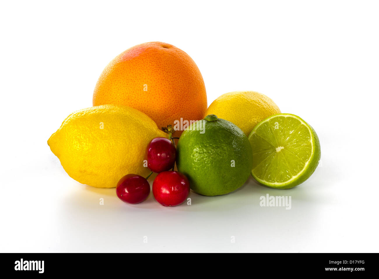 Grapefruit, lemons, limes and cherries still life on a white background ...