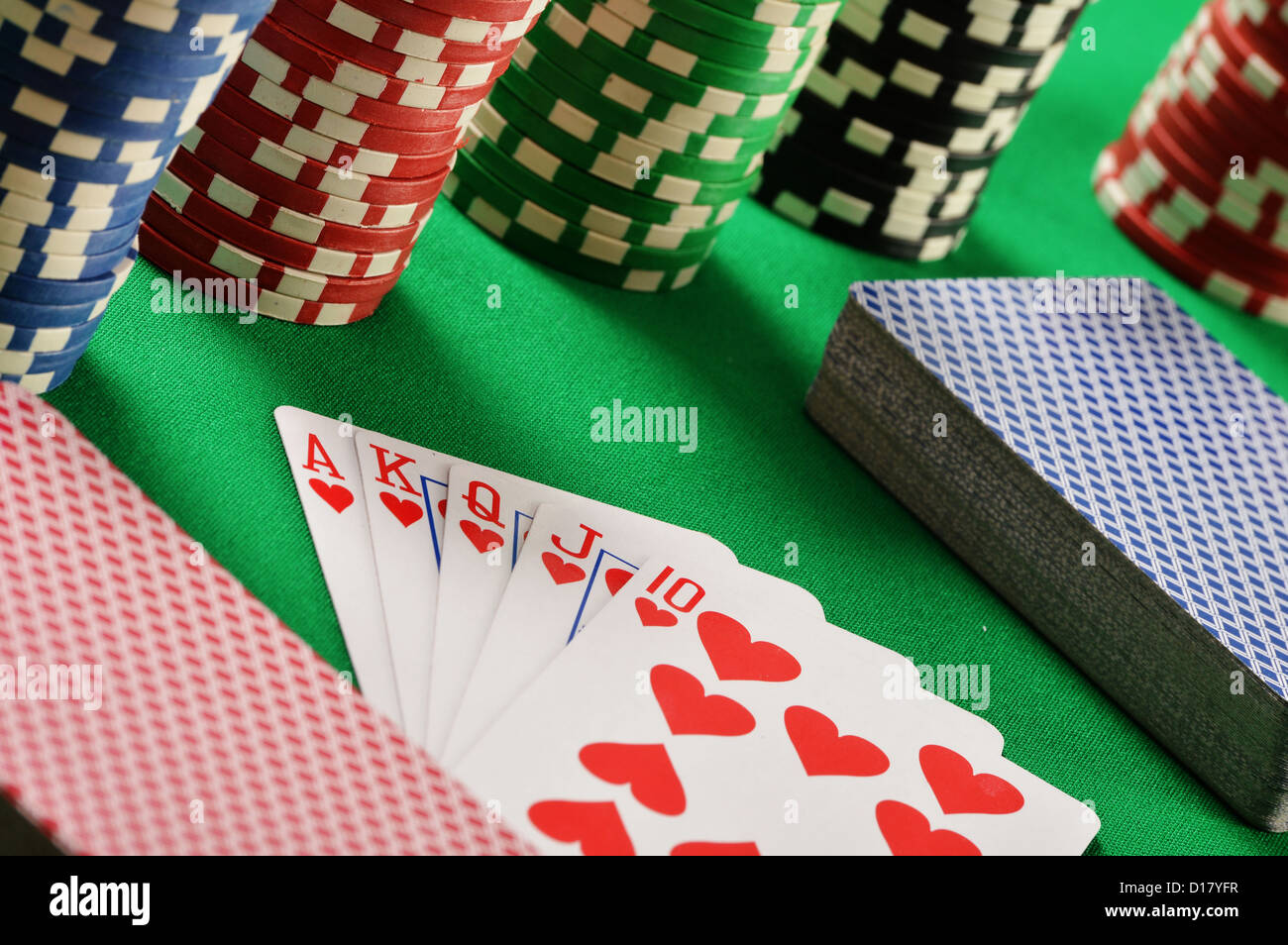 Composition with playing cards on green table Stock Photo - Alamy