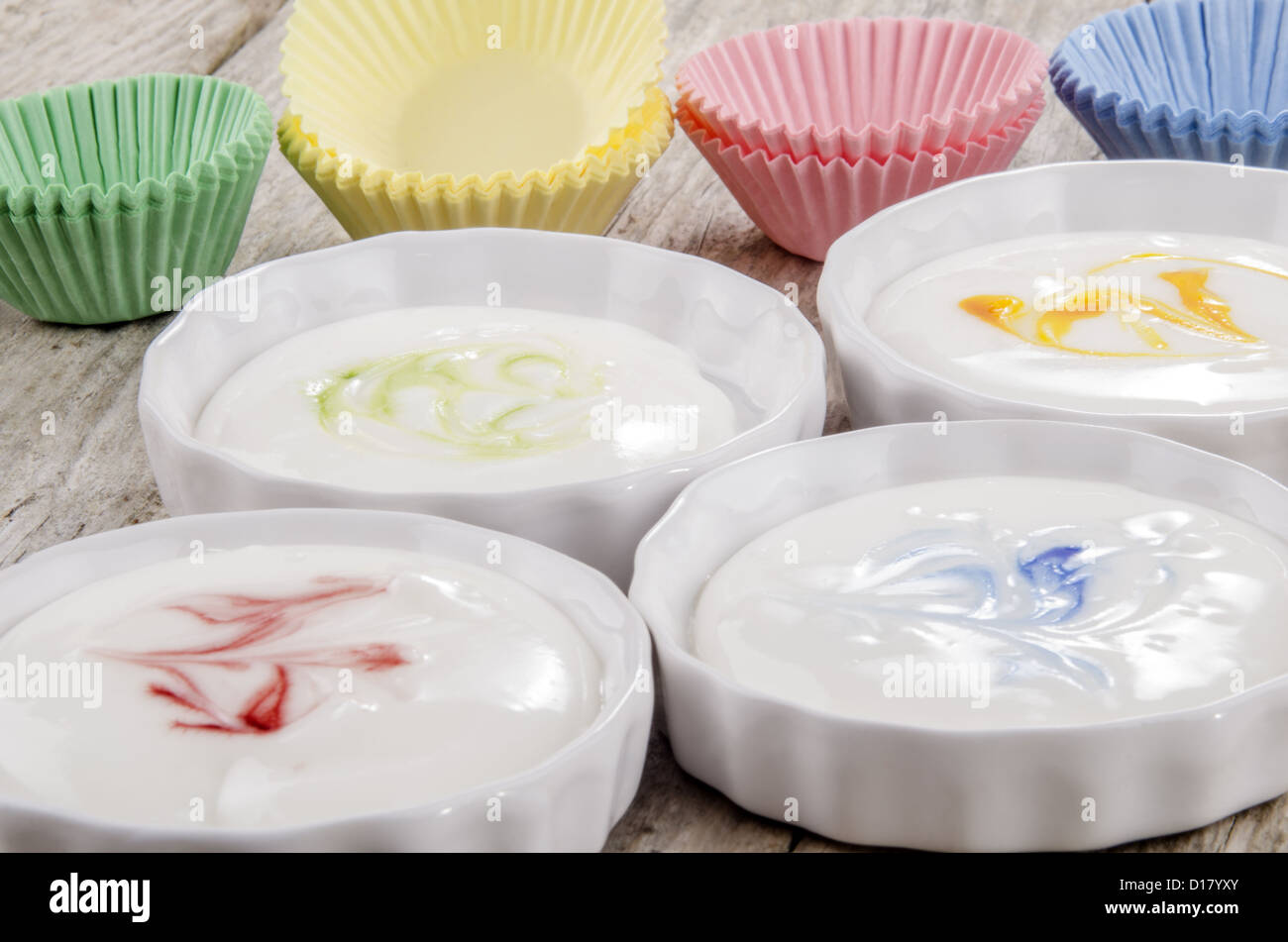 icing sugar with different colors mixed in white bowls Stock Photo - Alamy