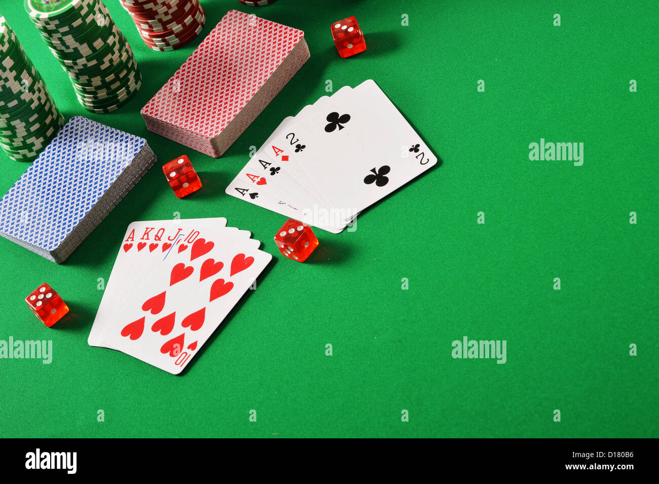 Composition with playing cards on green table Stock Photo - Alamy