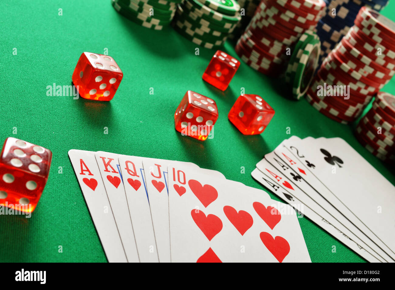 Composition with playing cards on green table Stock Photo - Alamy