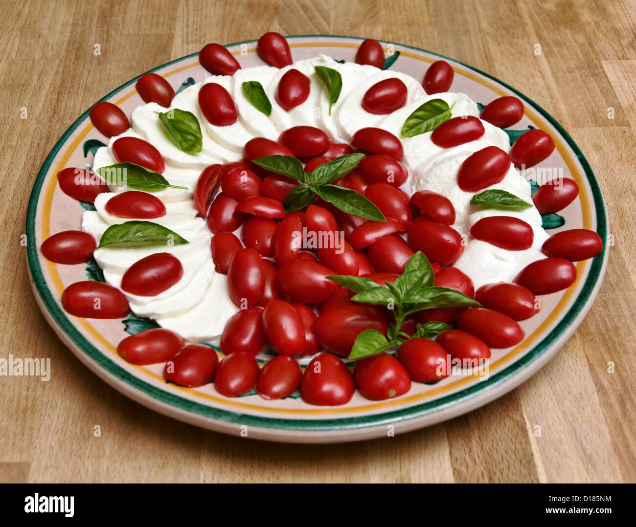 Italian tomatoes and mozzarella cheese salad served with olive oil and ...
