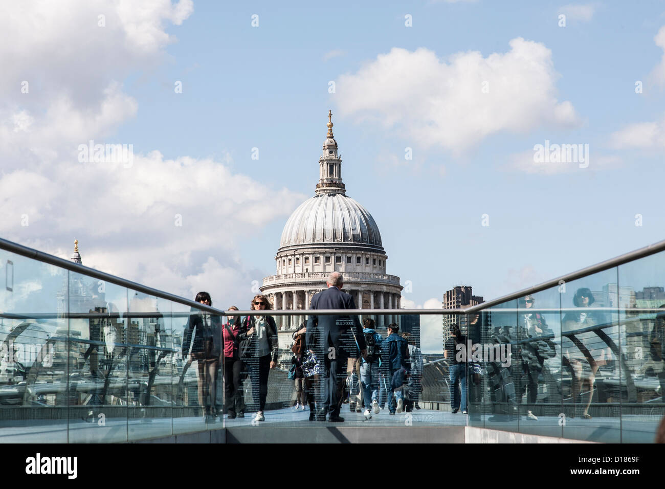 people rushing around on millennium bridge with st pauls in the ...