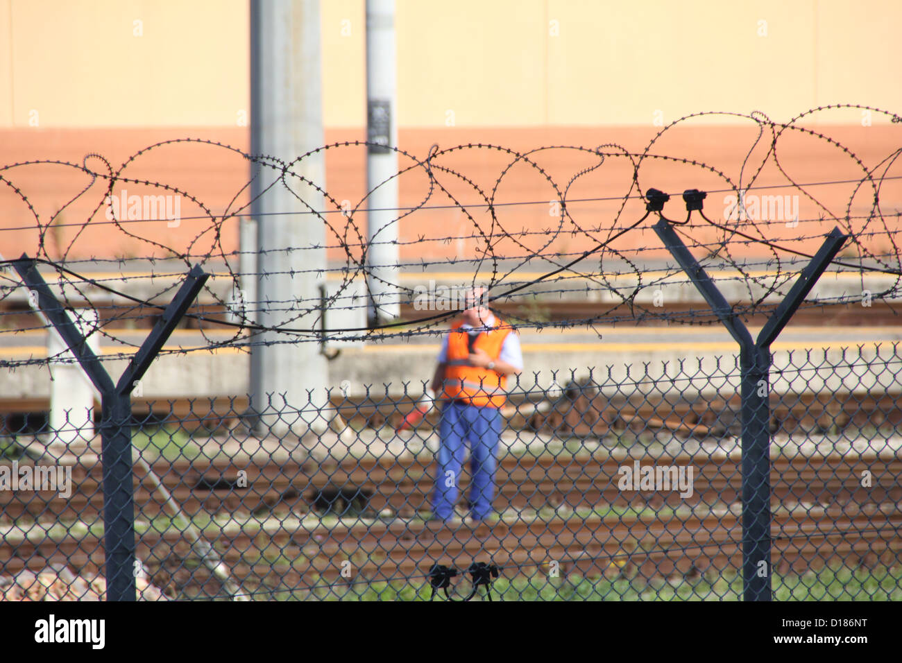 railway worker with high visibilty clothing on train tracks in rome ...