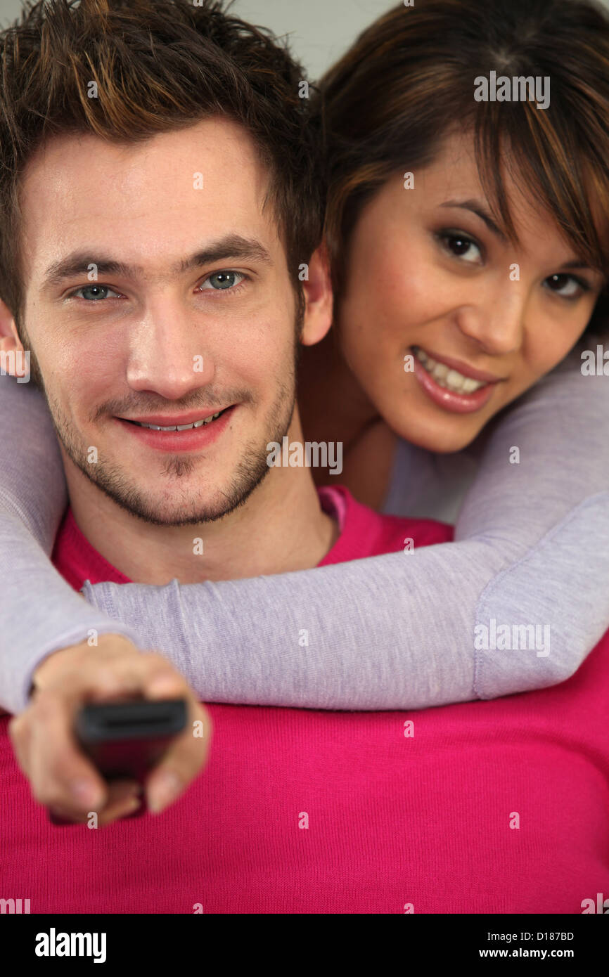 Couple with a remote control Stock Photo - Alamy