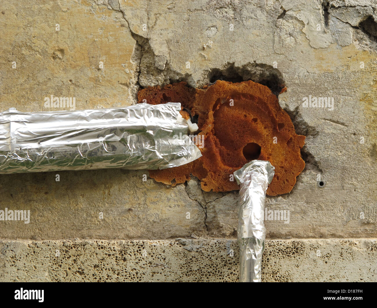 insulation protective foil cover on pipes entering building Stock Photo ...