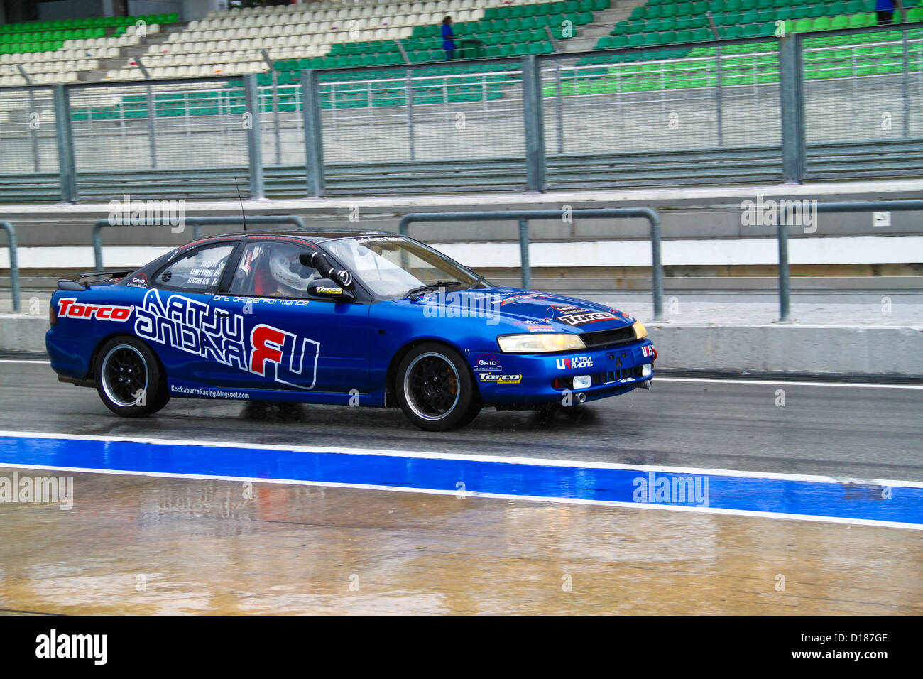 A modified street car on the rainy track of Sepang International ...