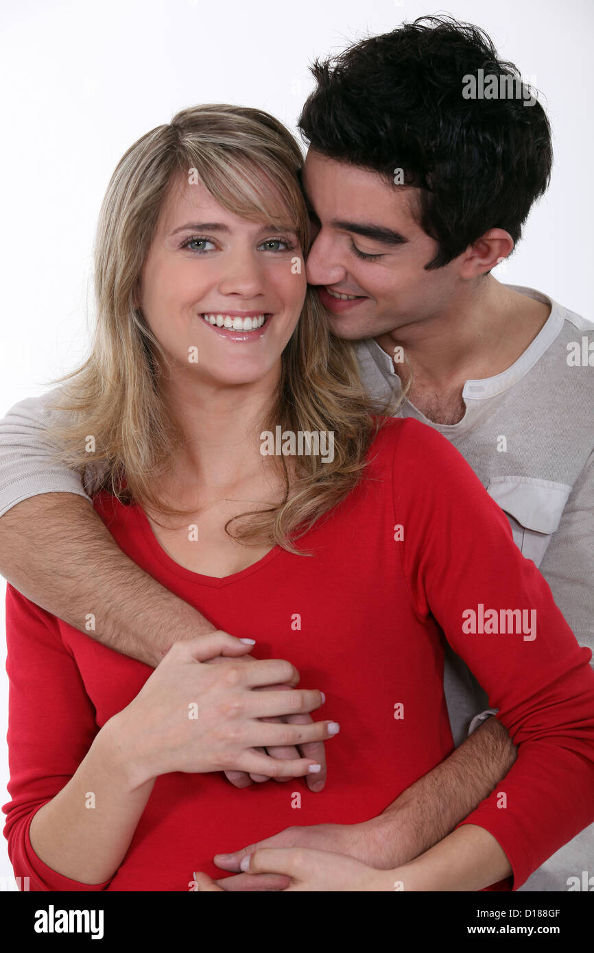 Couple hugging in studio Stock Photo - Alamy