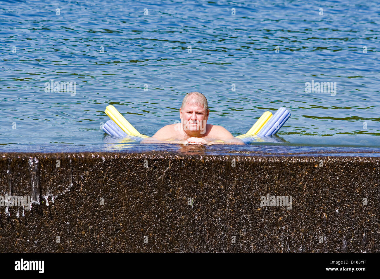 A adult man cooling off in a lake Stock Photo - Alamy