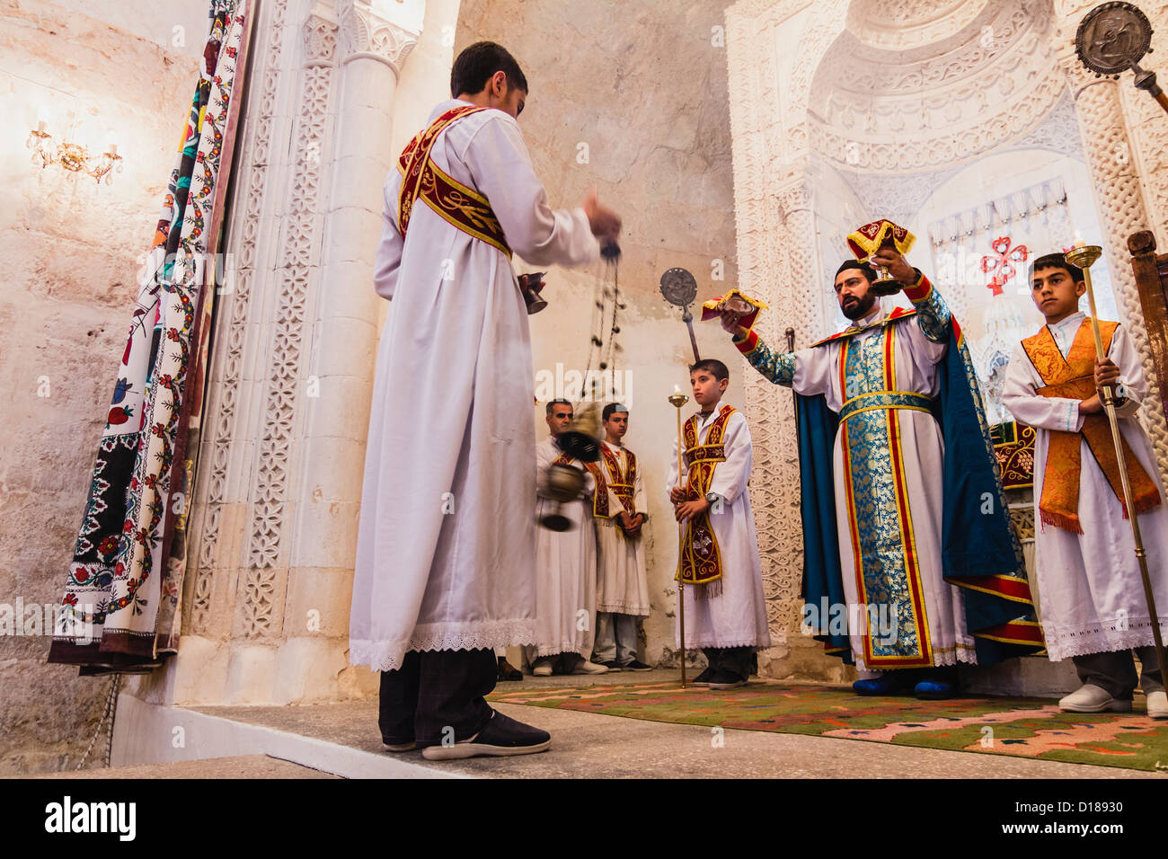 A Syriac Christian priest celebrating mass at an old church in Midyat ...