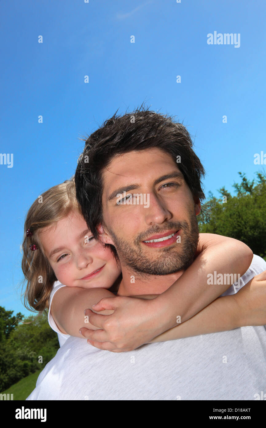 Dad giving his daughter a piggy back Stock Photo - Alamy