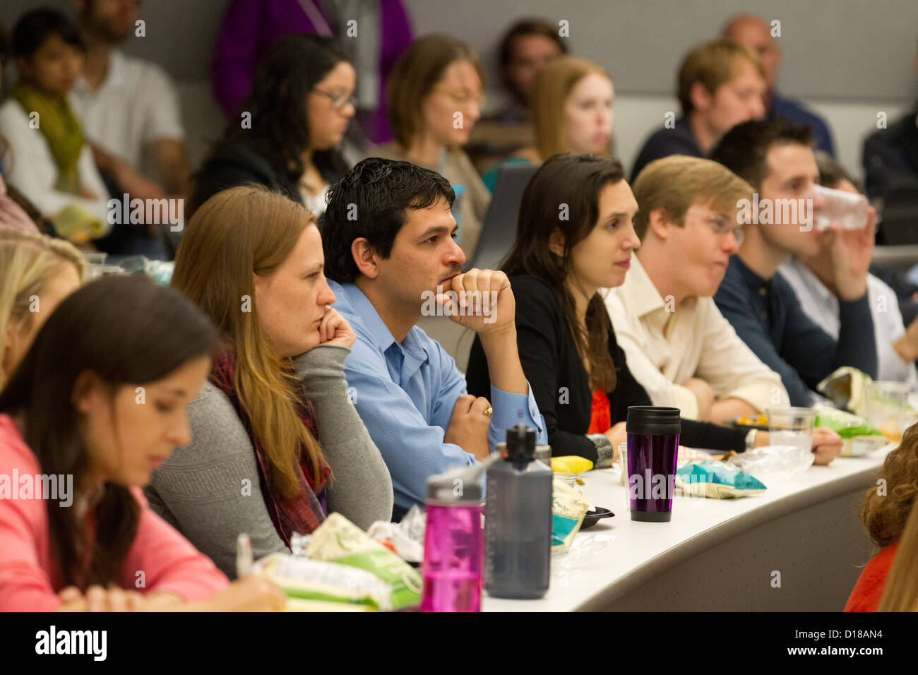 group of students including various age groups listen to lecture in ...