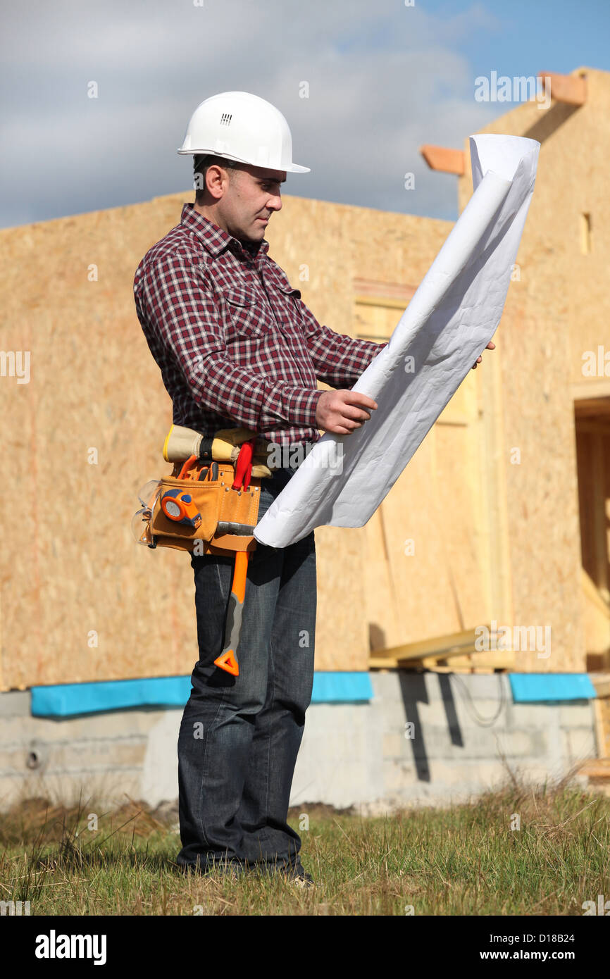 Foreman overseeing house build Stock Photo - Alamy
