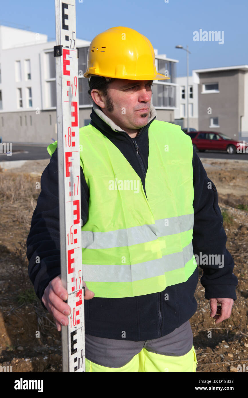 Workers with metal ruler Stock Photo - Alamy