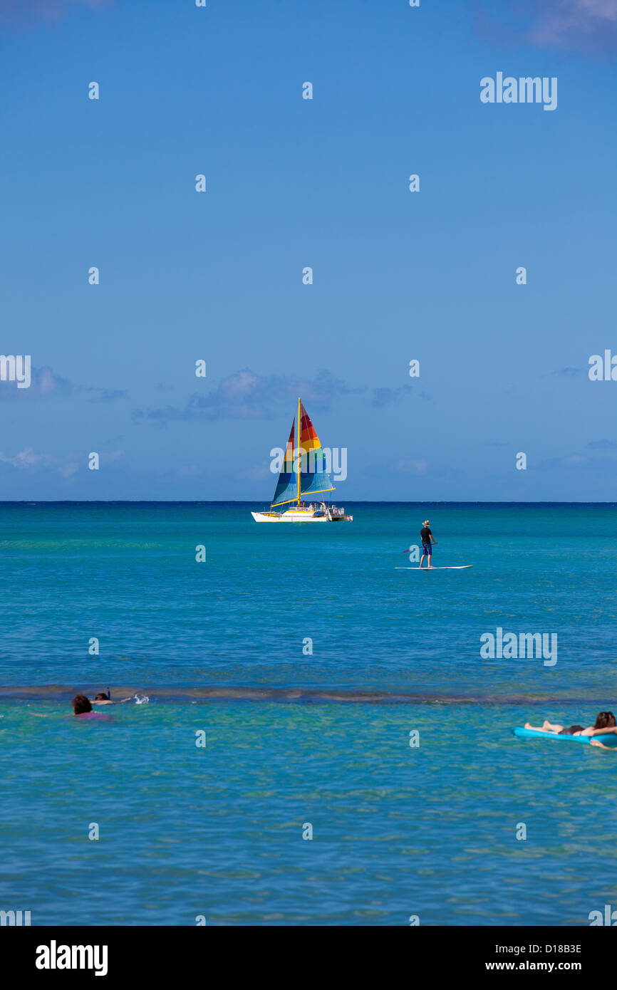 Ocean boat rainbow sail waterfront beach pacific ocean Stock Photo - Alamy