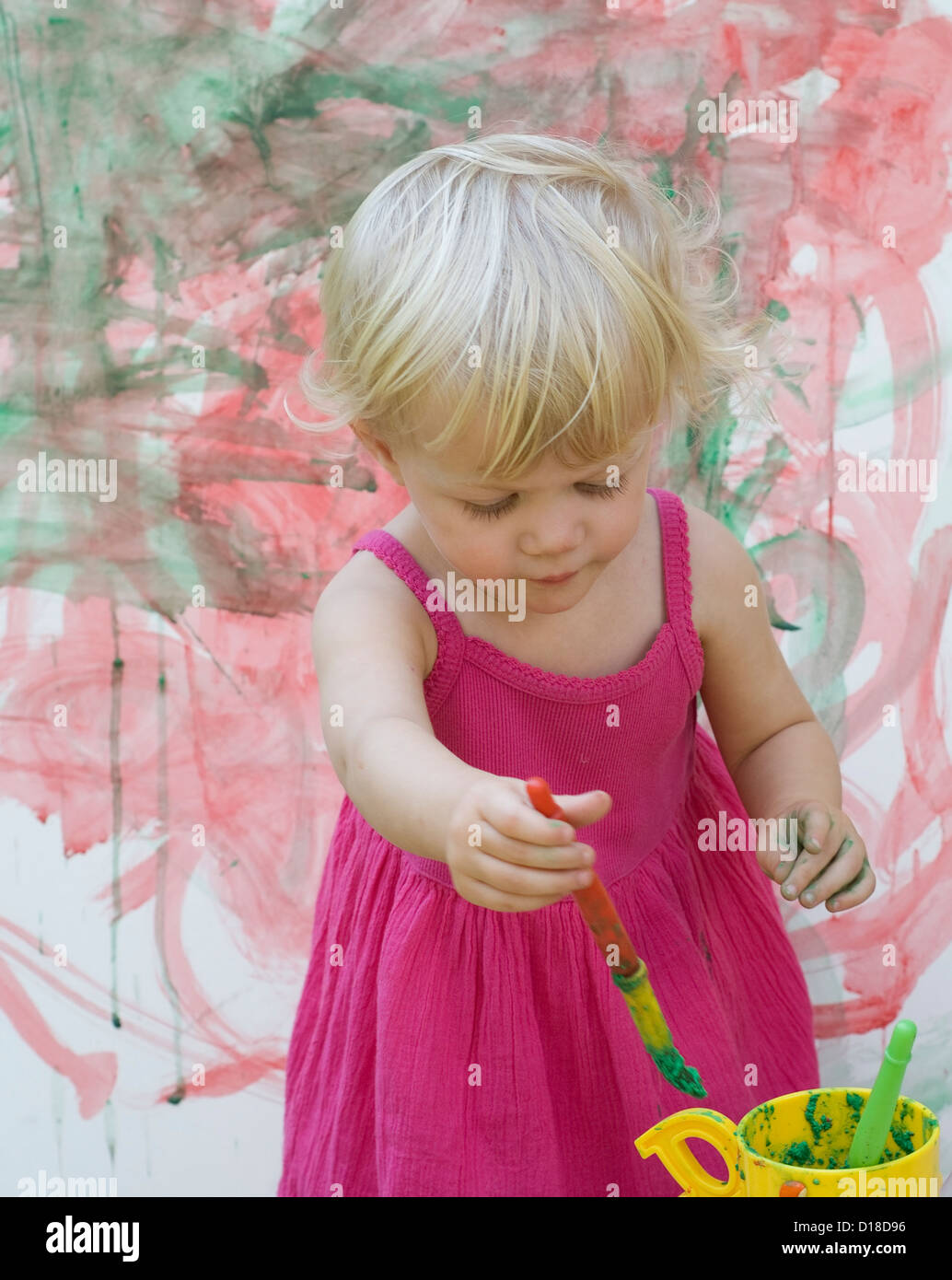 Baby little girl playing with paint artist Stock Photo - Alamy