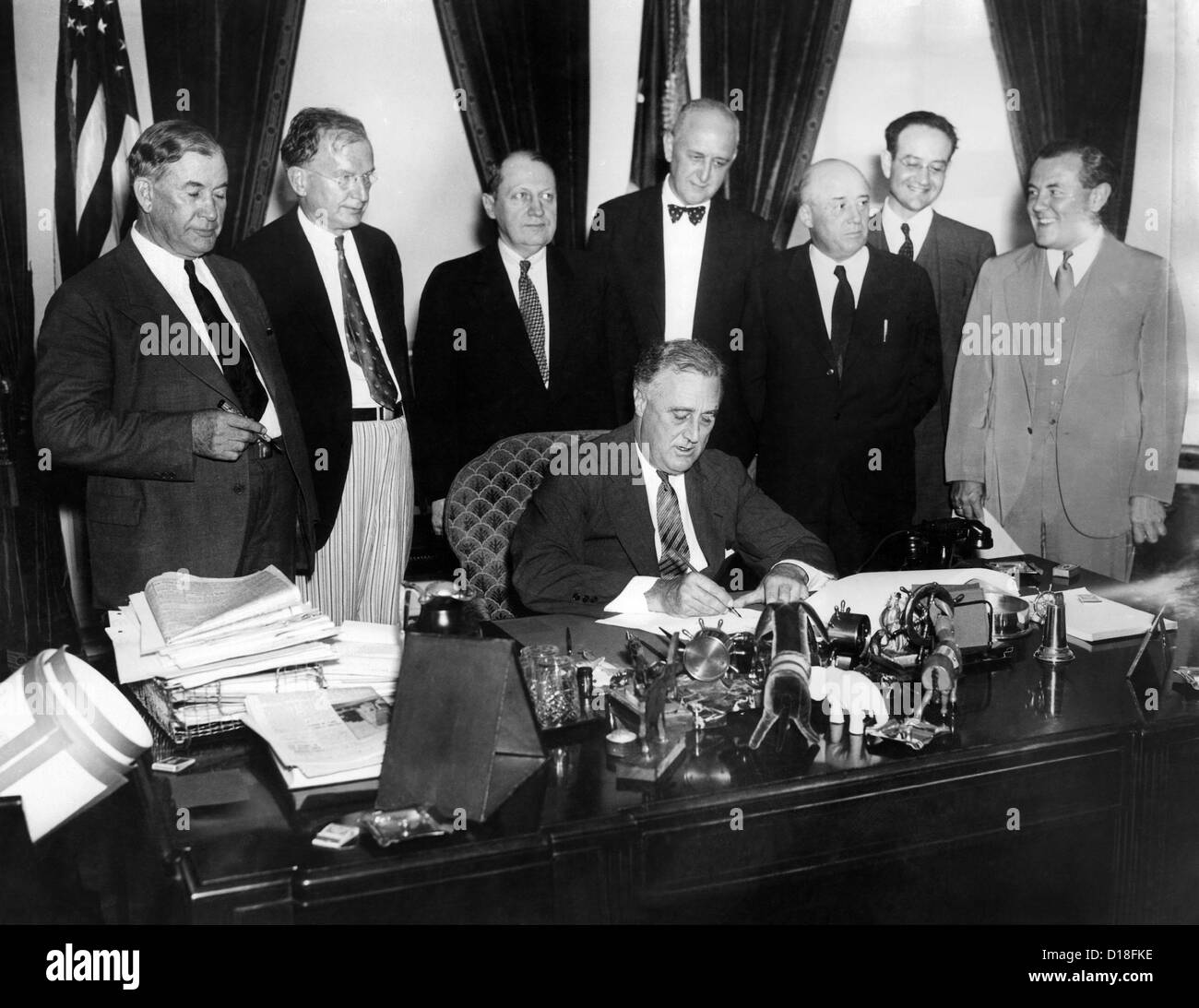 President Franklin Roosevelt, signs the Public Utility Holding Company ...