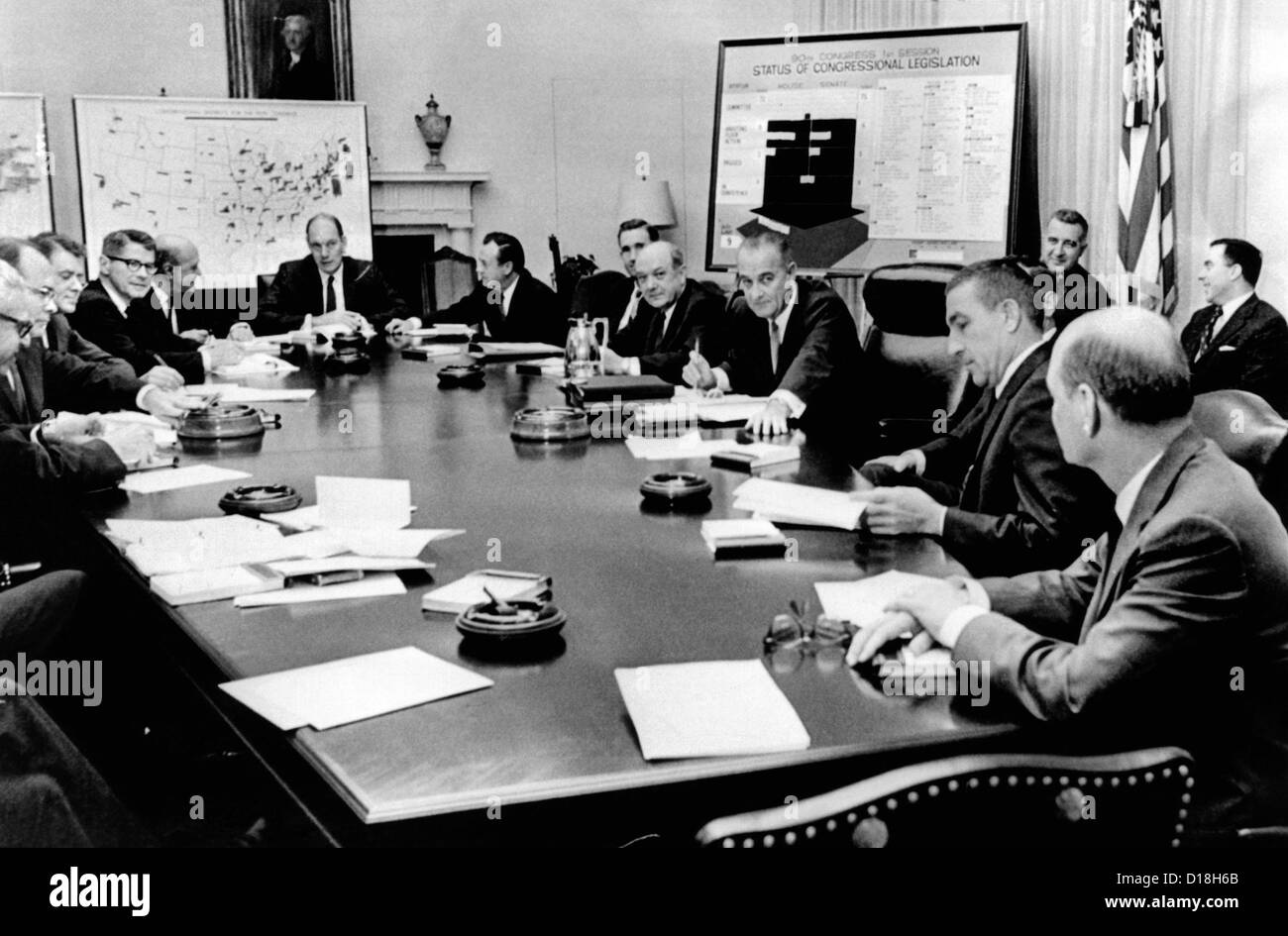 President Lyndon Johnson meets with his Cabinet. A chart lists the ...