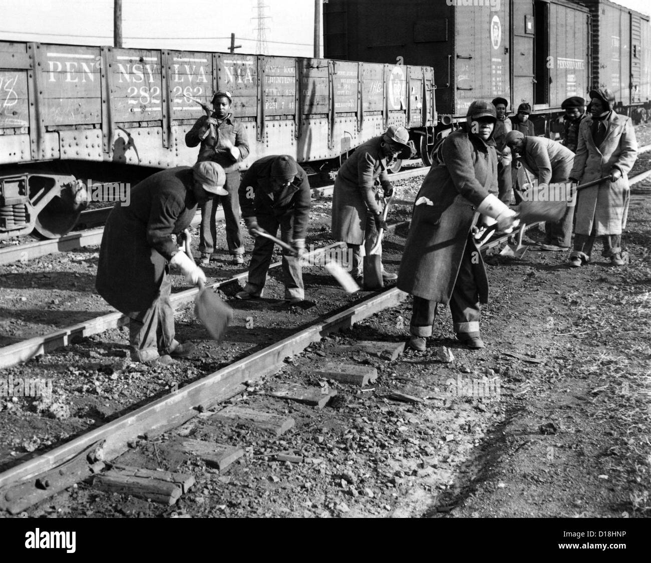 African American women working on a railroad crew. They perform track ...