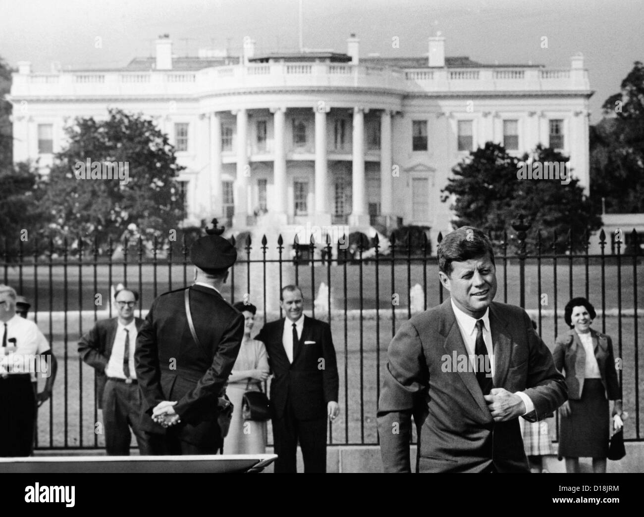 President John Kennedy in front of the White House. He is taking a ...