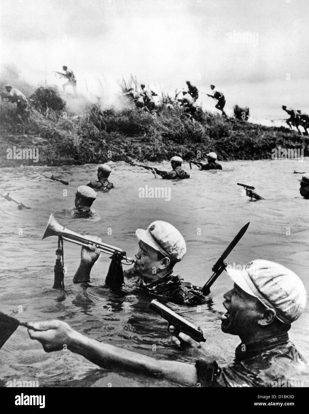 Chinese Communist soldiers cross a river during training. The bugle was ...