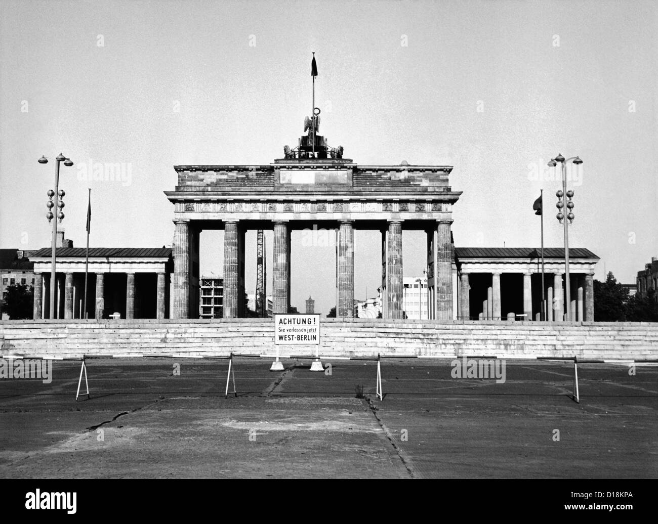 The Brandenburg Gate in East Berlin behind the Berlin Wall. A sign in ...
