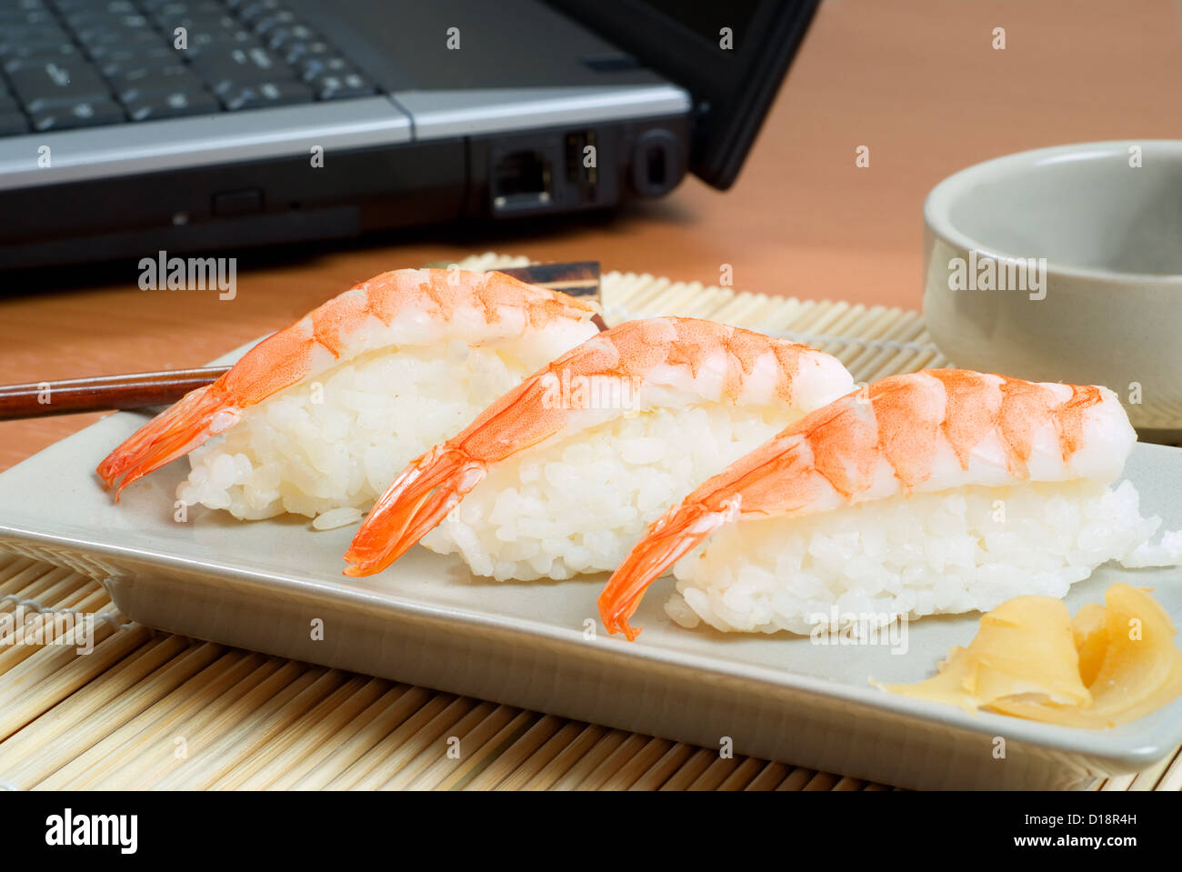 Office business lunch platter of sushi prawn plate with chopsticks ...