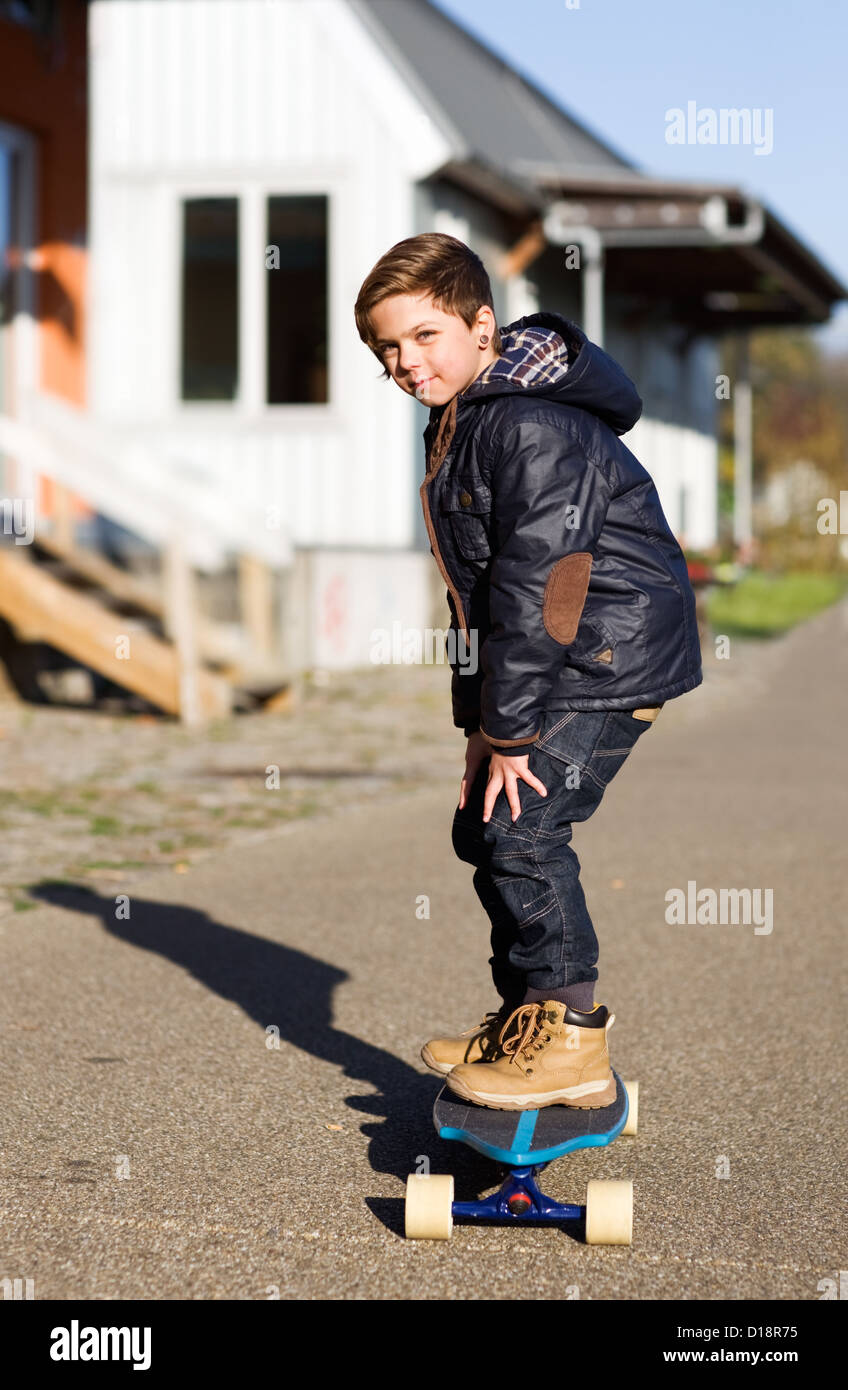 Portrait of boy on skateboard Stock Photo - Alamy