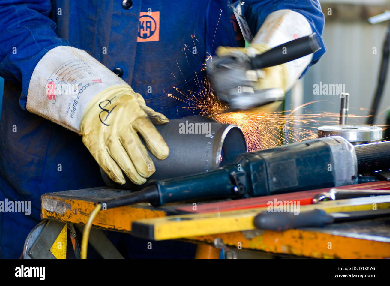 Worker with angle grinder Stock Photo - Alamy