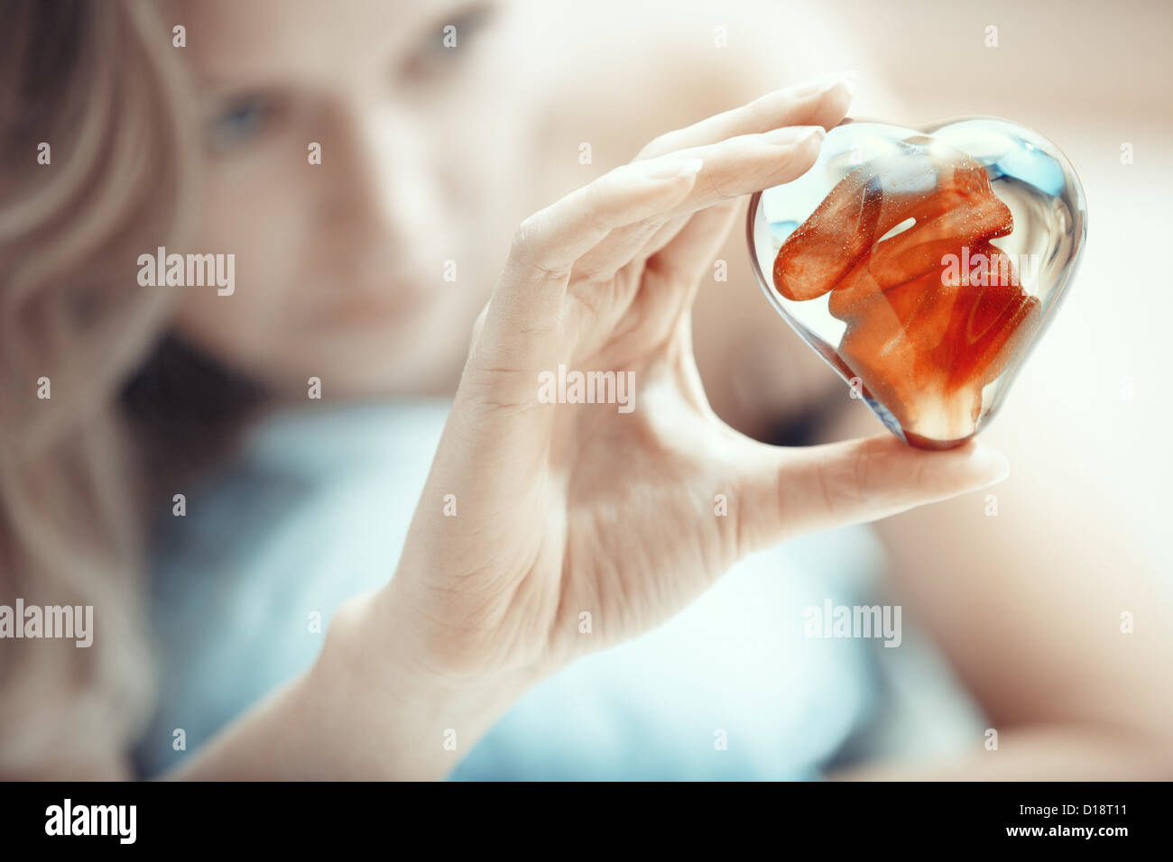 Woman hands holding heart shape object Stock Photo - Alamy