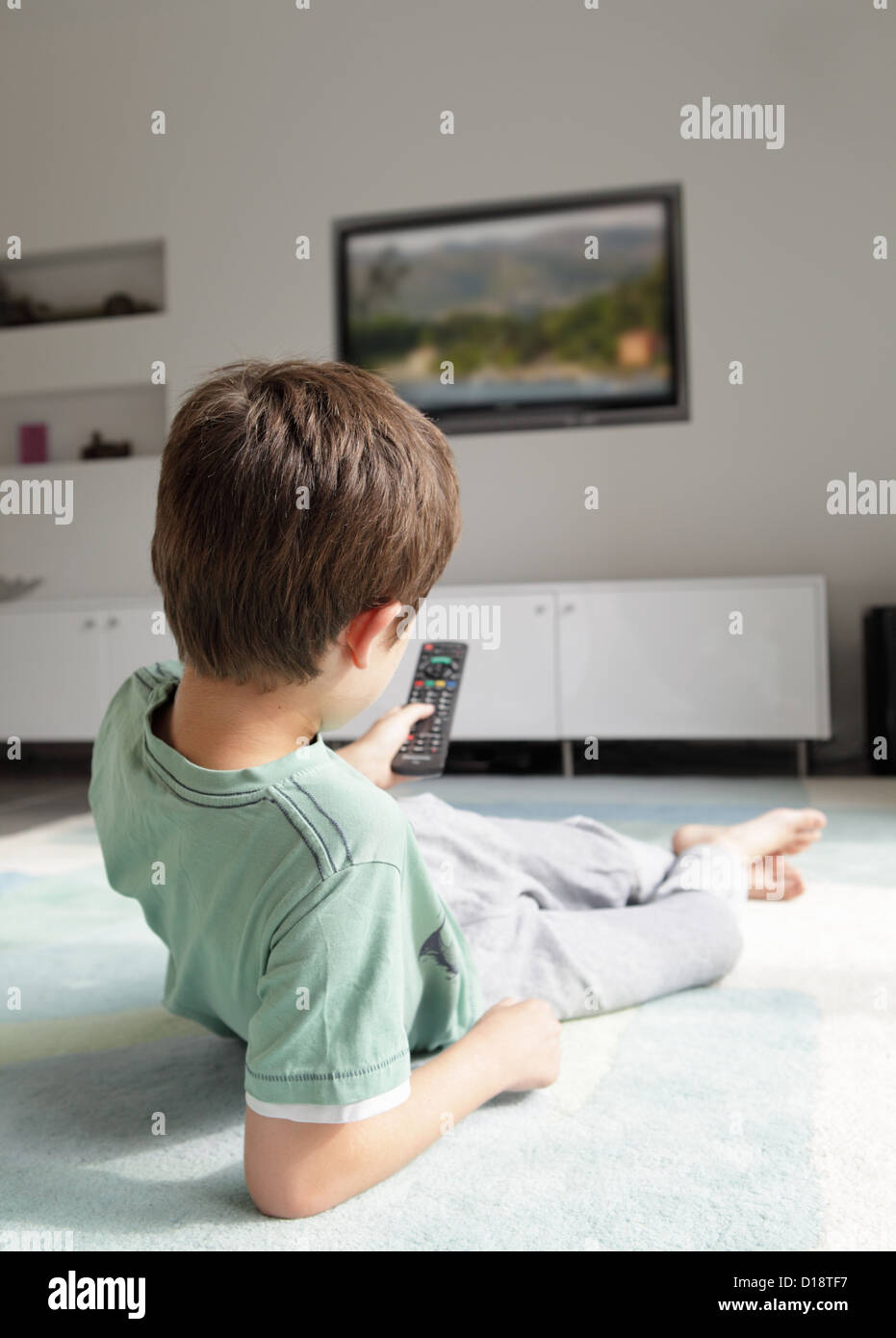 Boy watching television at home Stock Photo - Alamy