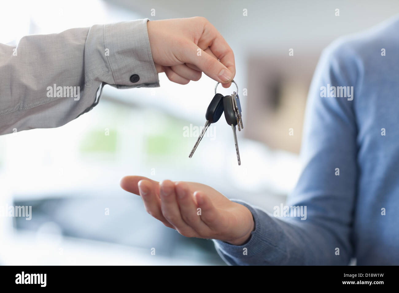 Man giving keys to someone Stock Photo - Alamy