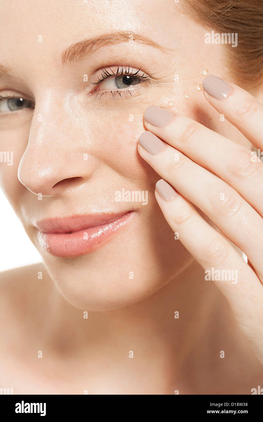 Woman applying eye gel Stock Photo - Alamy