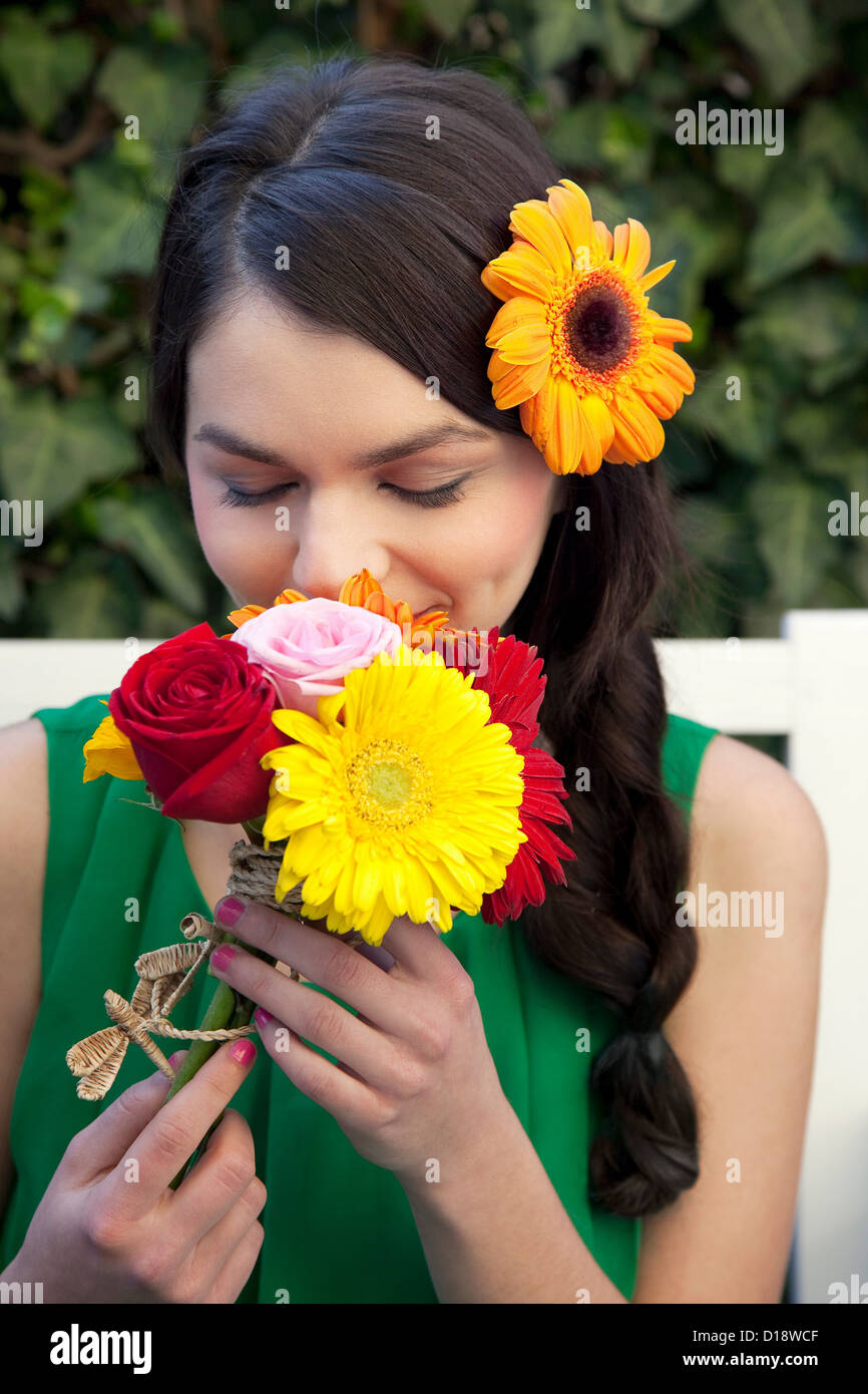 Woman smelling flowers Stock Photo - Alamy