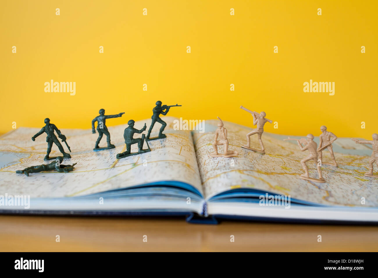 Toy soldiers fighting on map Stock Photo - Alamy