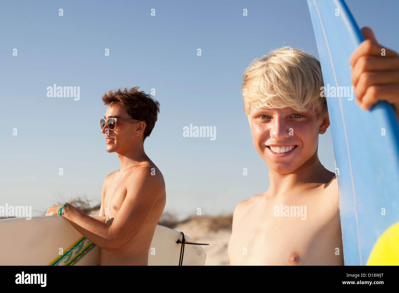 Two young men with surfboards Stock Photo - Alamy