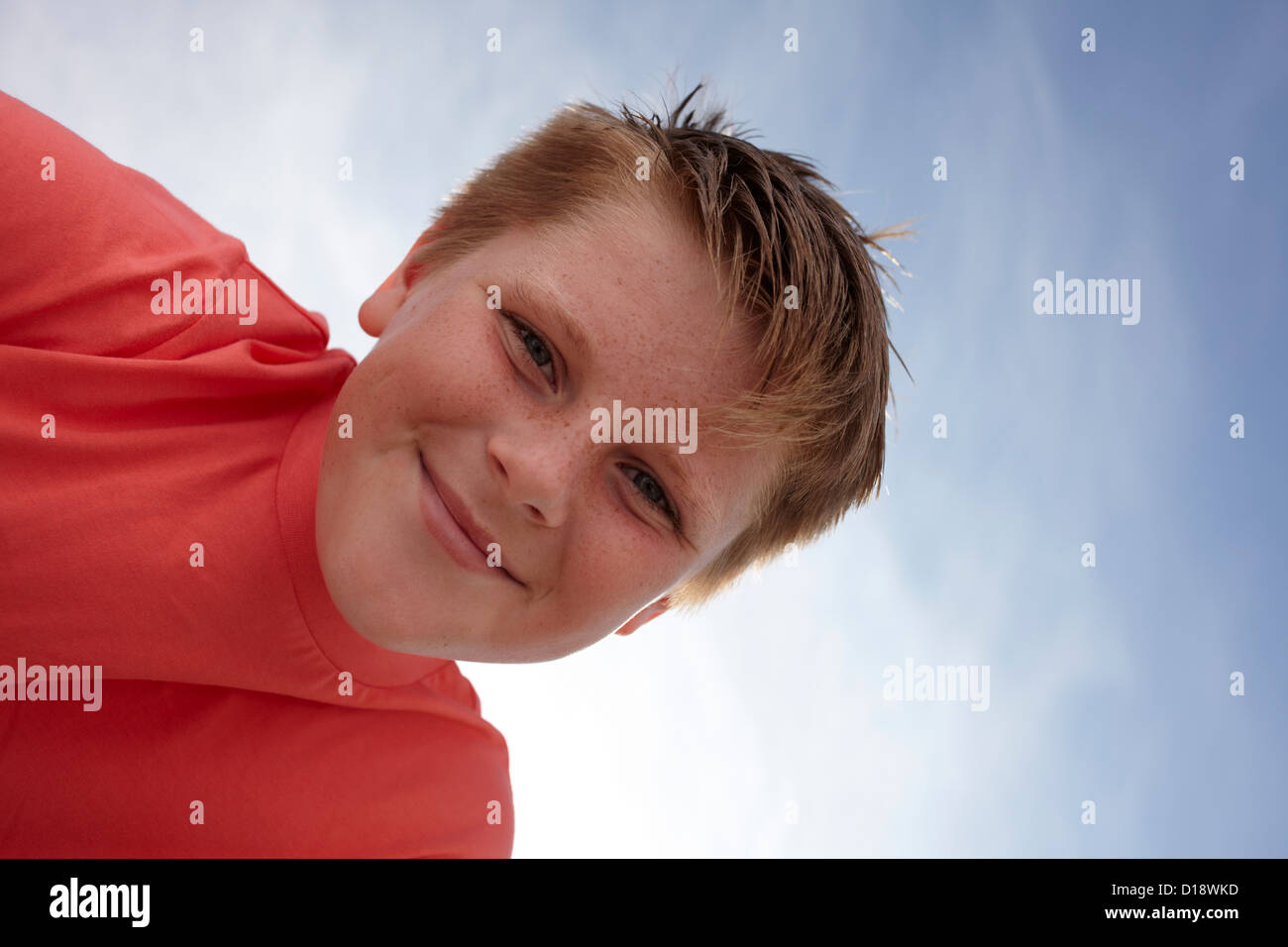 Boy looking at camera, viewed from below Stock Photo - Alamy