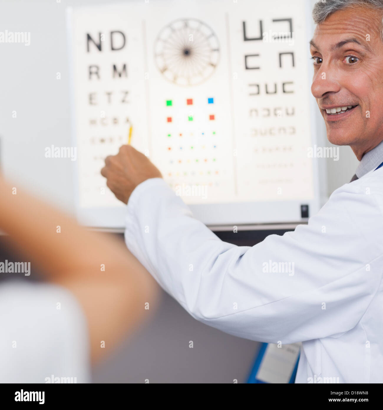 Doctor smiling while doing an eye test on a patient in a hospital Stock ...