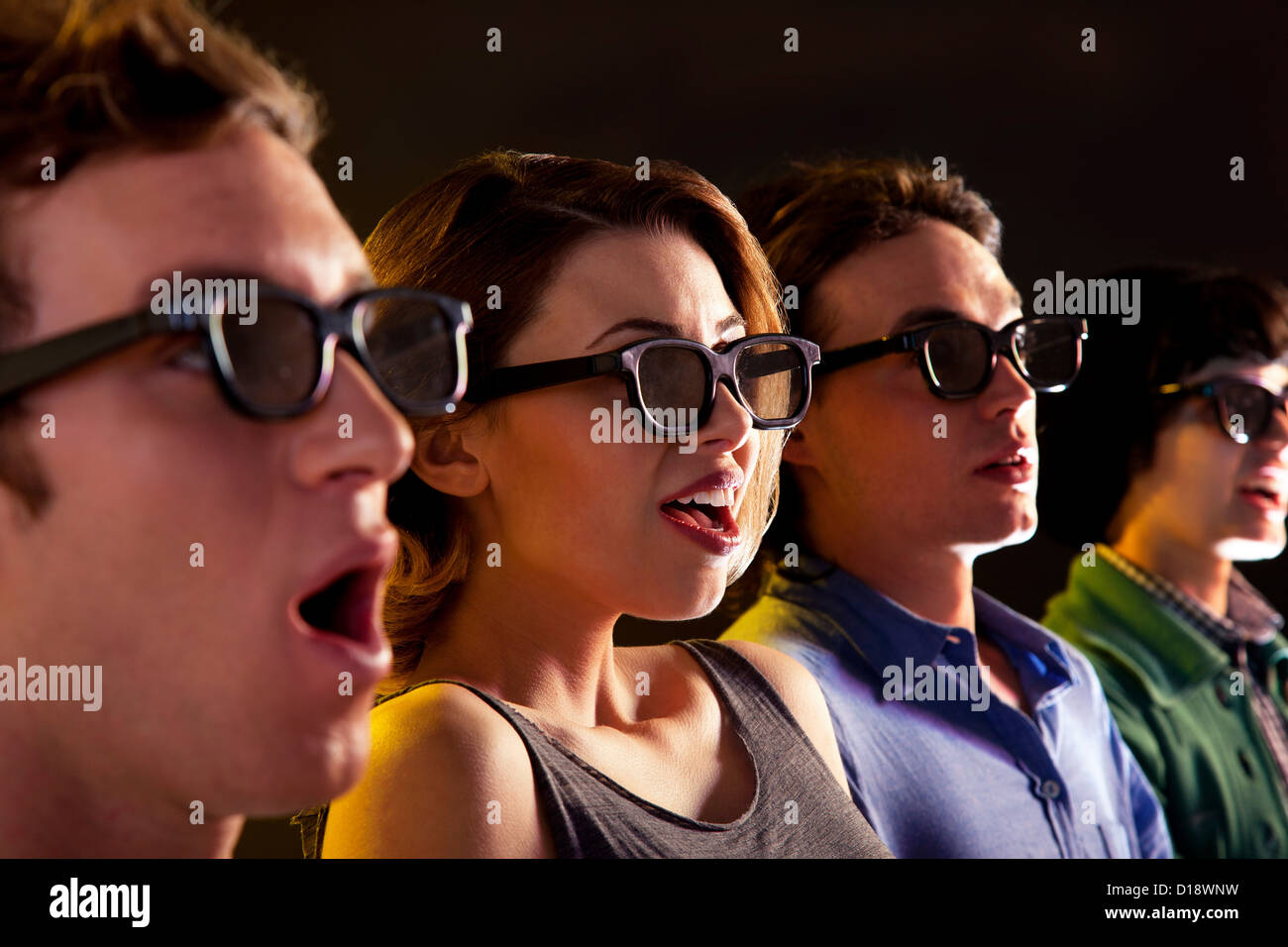 Row of people watching 3D movie Stock Photo - Alamy